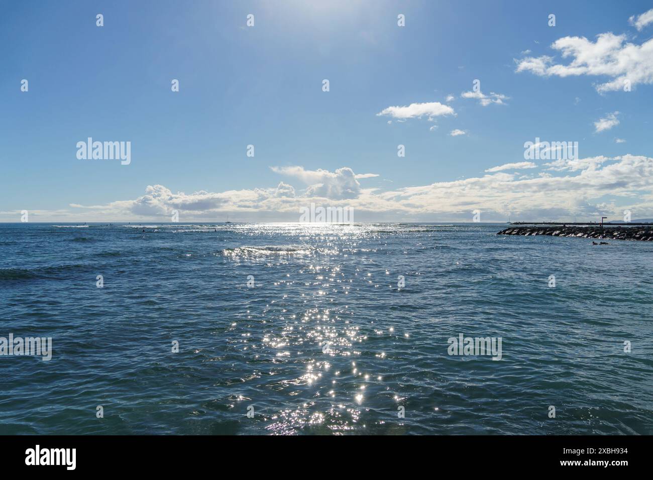 The radiant sun is mirrored in the tranquil water of the expansive ...