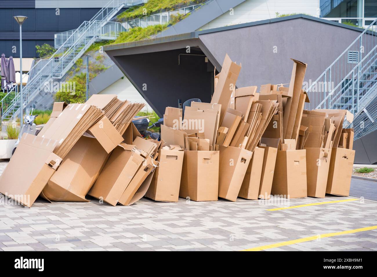 Pile of cardboard boxes ready for recycling outside a parking Stock ...