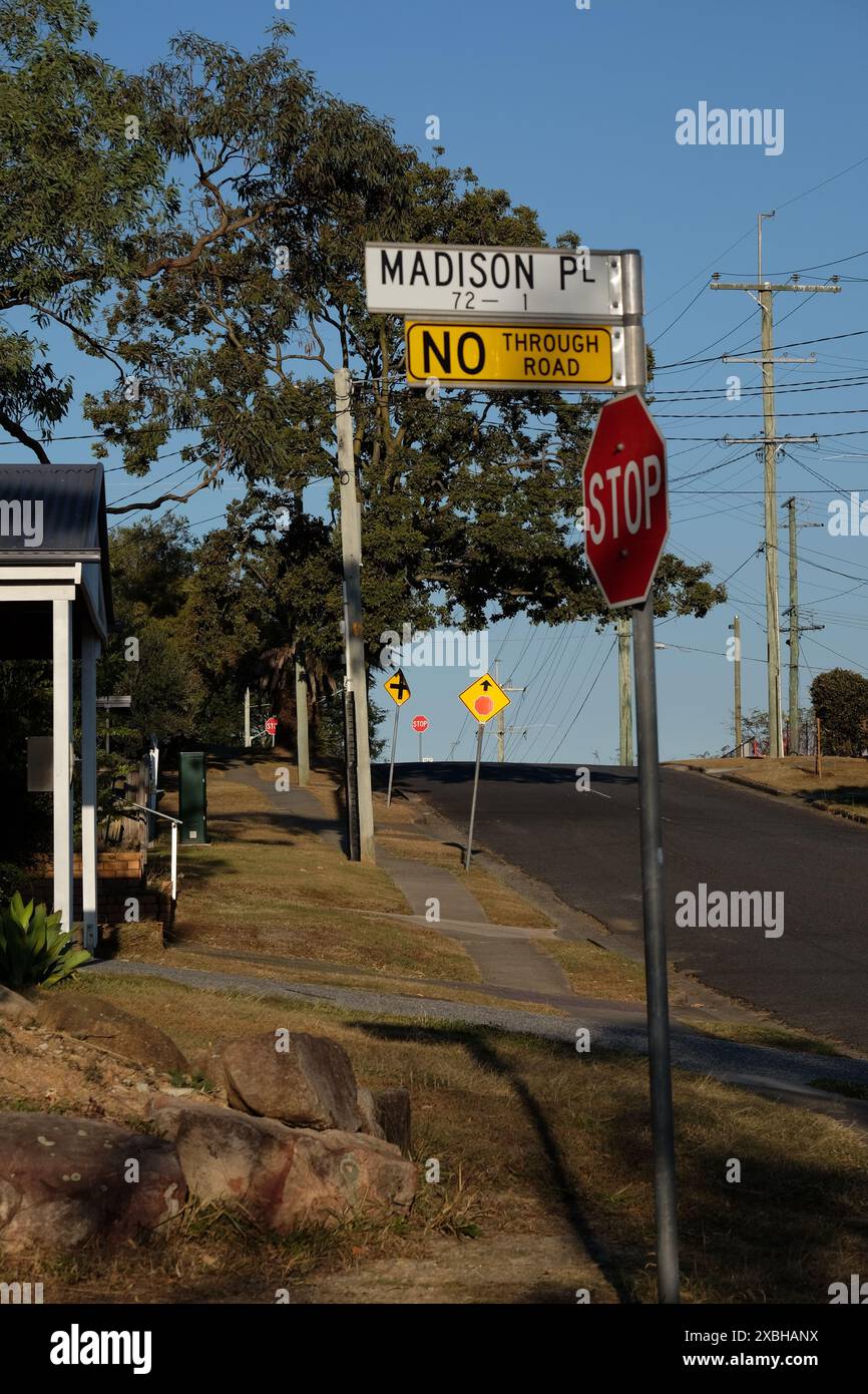 Stop sign and power lines on a hilly suburban street in Carina ...