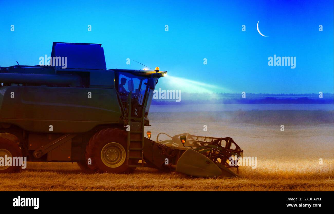 Cleaning of wheat of a crop at night combine Stock Photo - Alamy