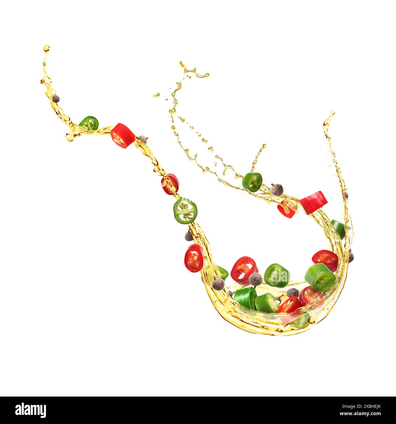 Cooking oil splash with chili peppers and allspice in air on white ...