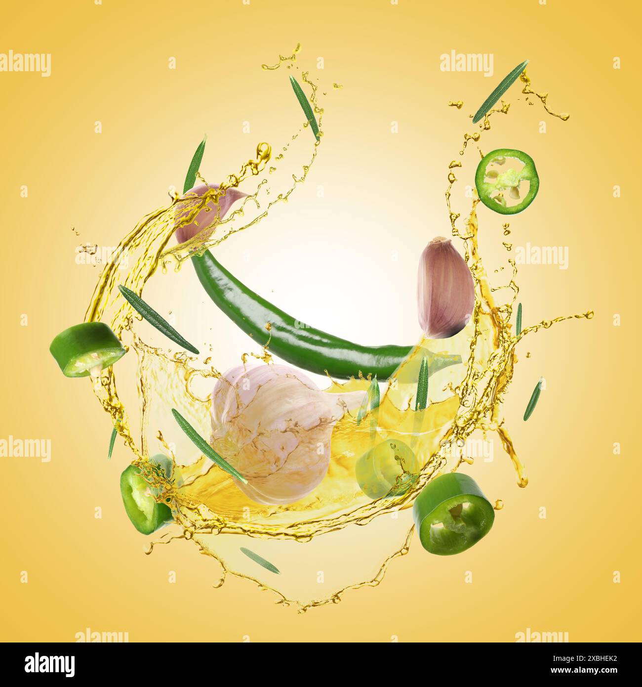 Cooking oil splash with chili pepper, garlic and rosemary in air on ...