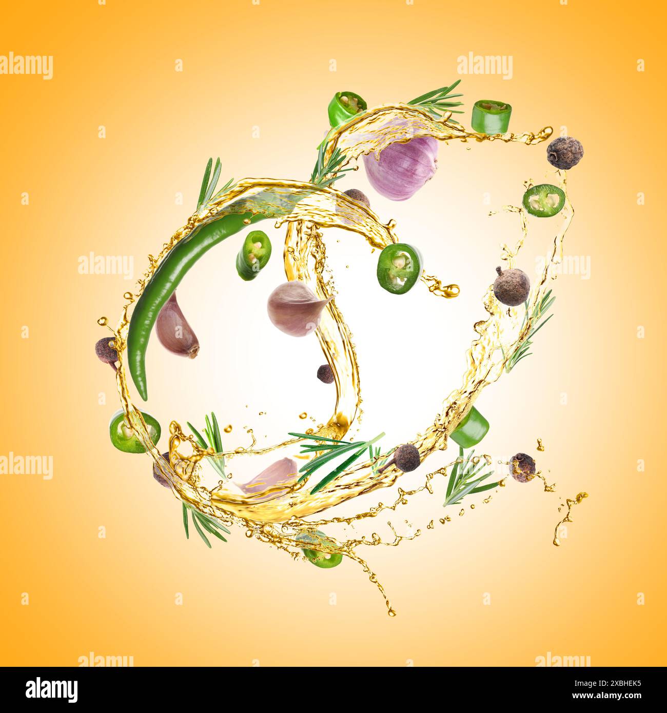 Cooking oil splash with chili pepper, rosemary, allspice and garlic in ...