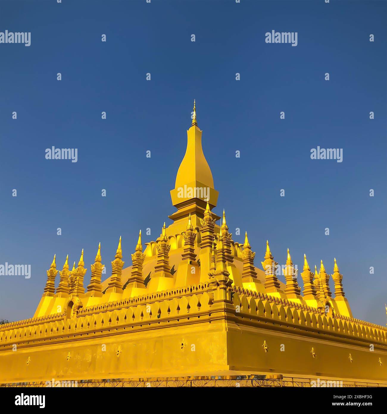 The golden tower of Pha That Luang Vientiane temple against the blue ...