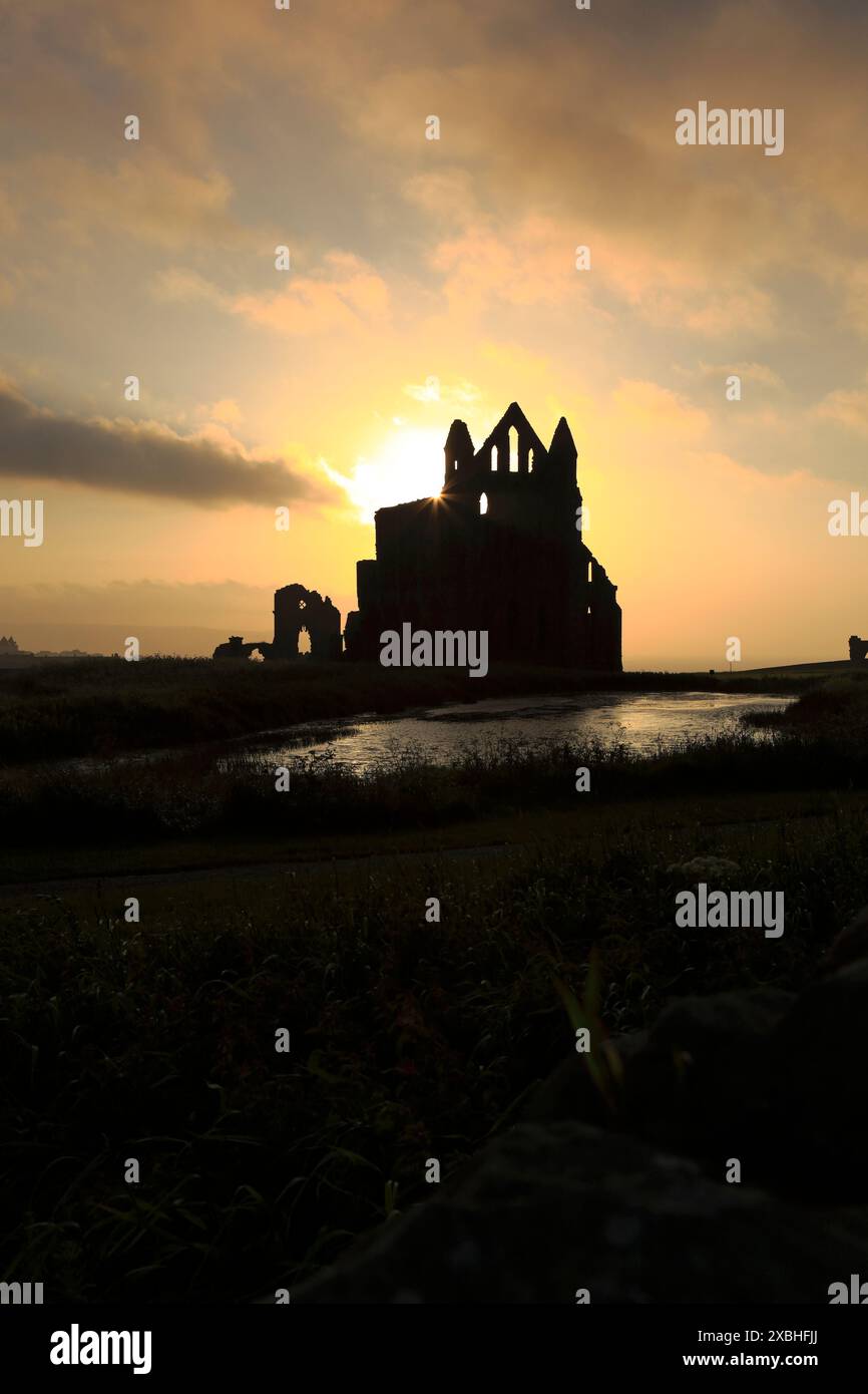 Historic ruins of Whitby Abbey and pond in silhouette, Whitby, North ...