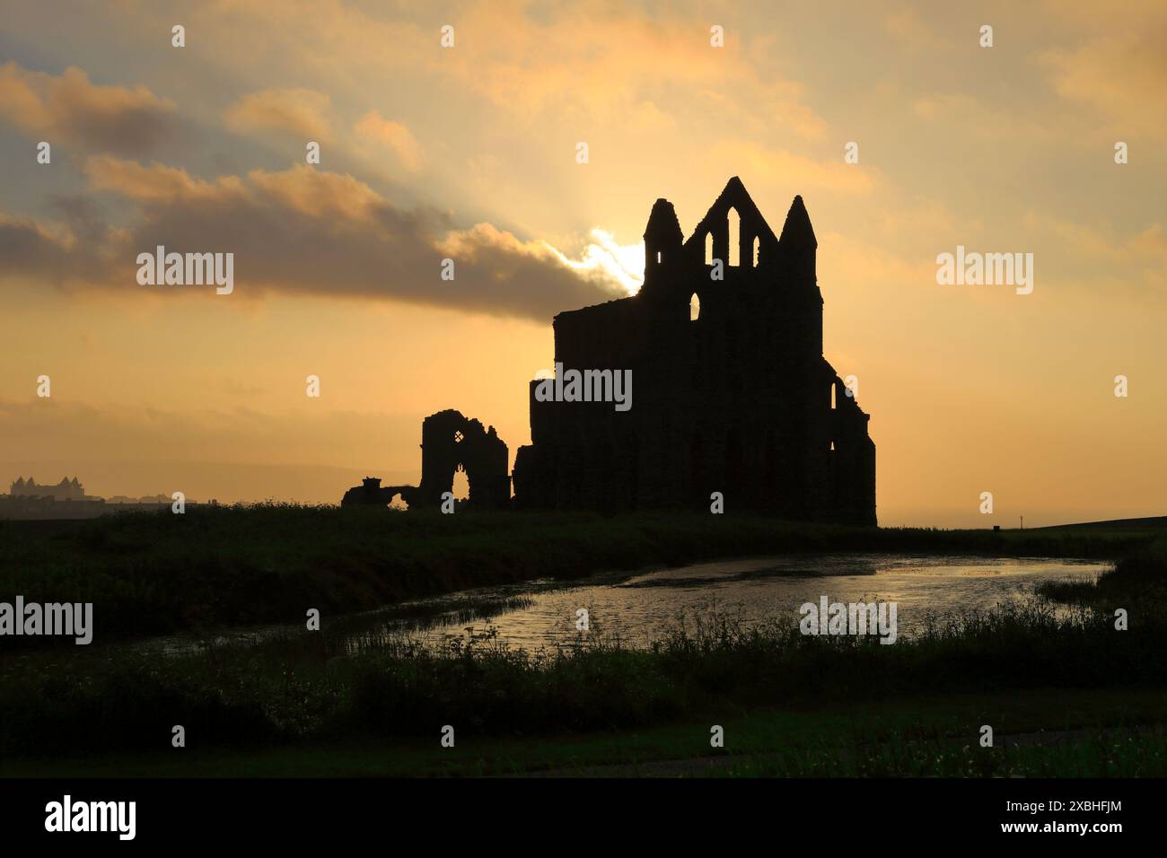 Historic ruins of Whitby Abbey and pond in silhouette, Whitby, North ...