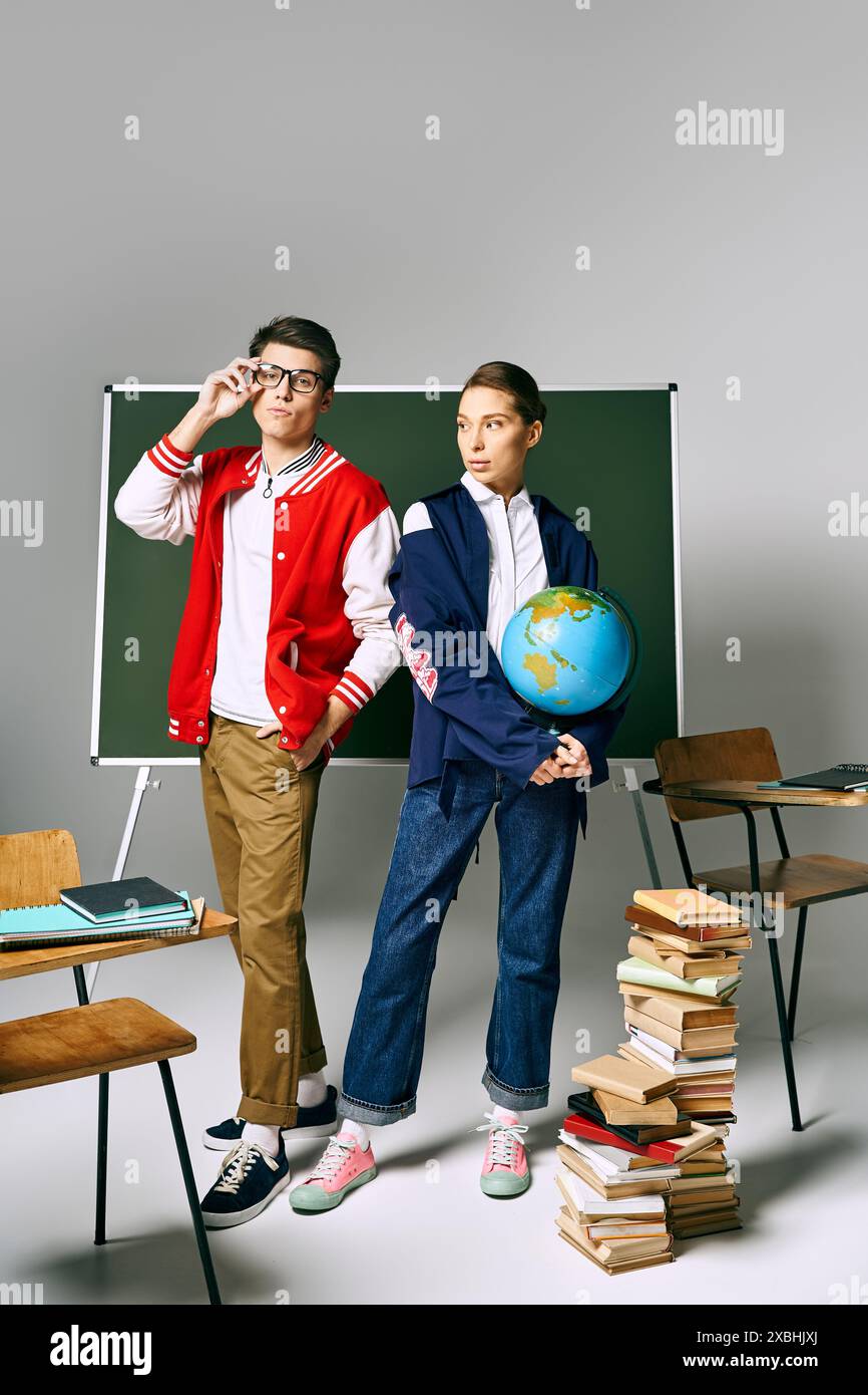 students in college attire standing by green board with books and globe ...