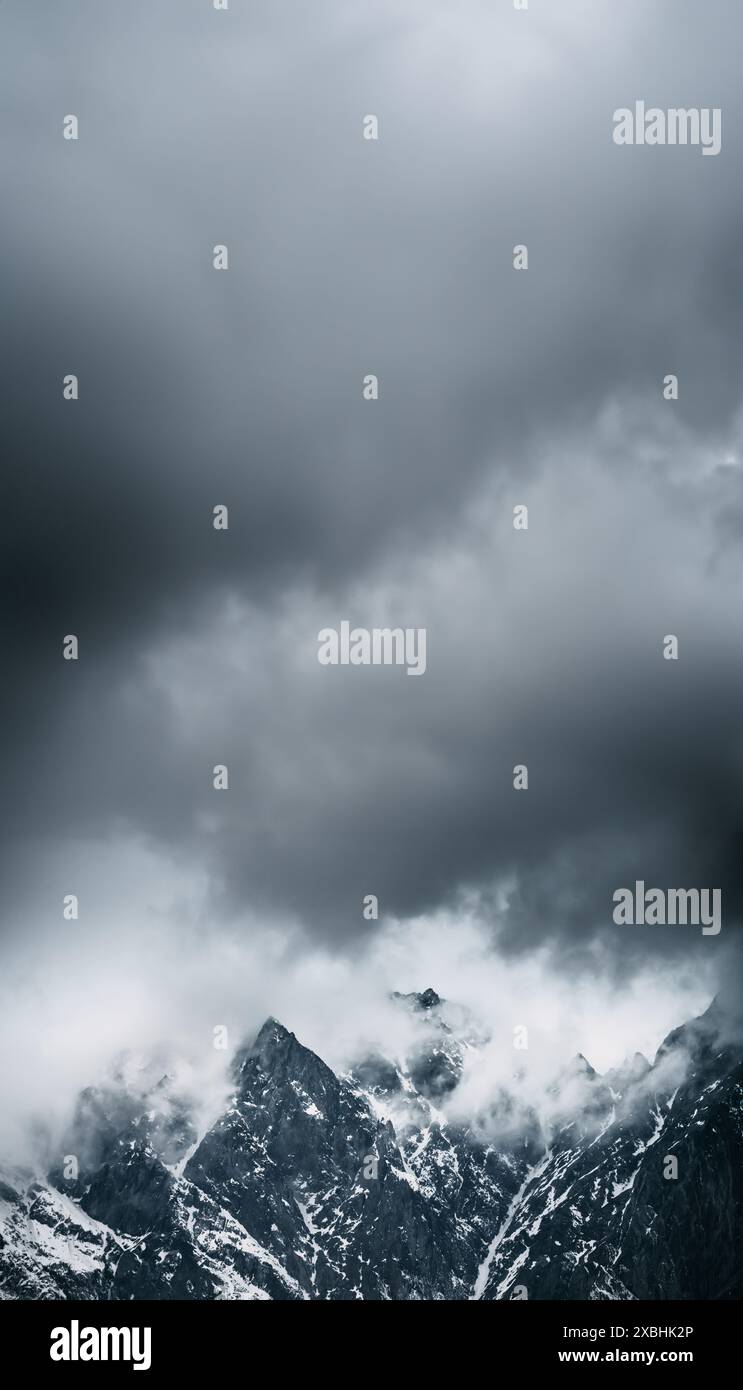 Clouds Fly Low Over Rocks. Mountains Peaks Covered With Snow. Varied ...