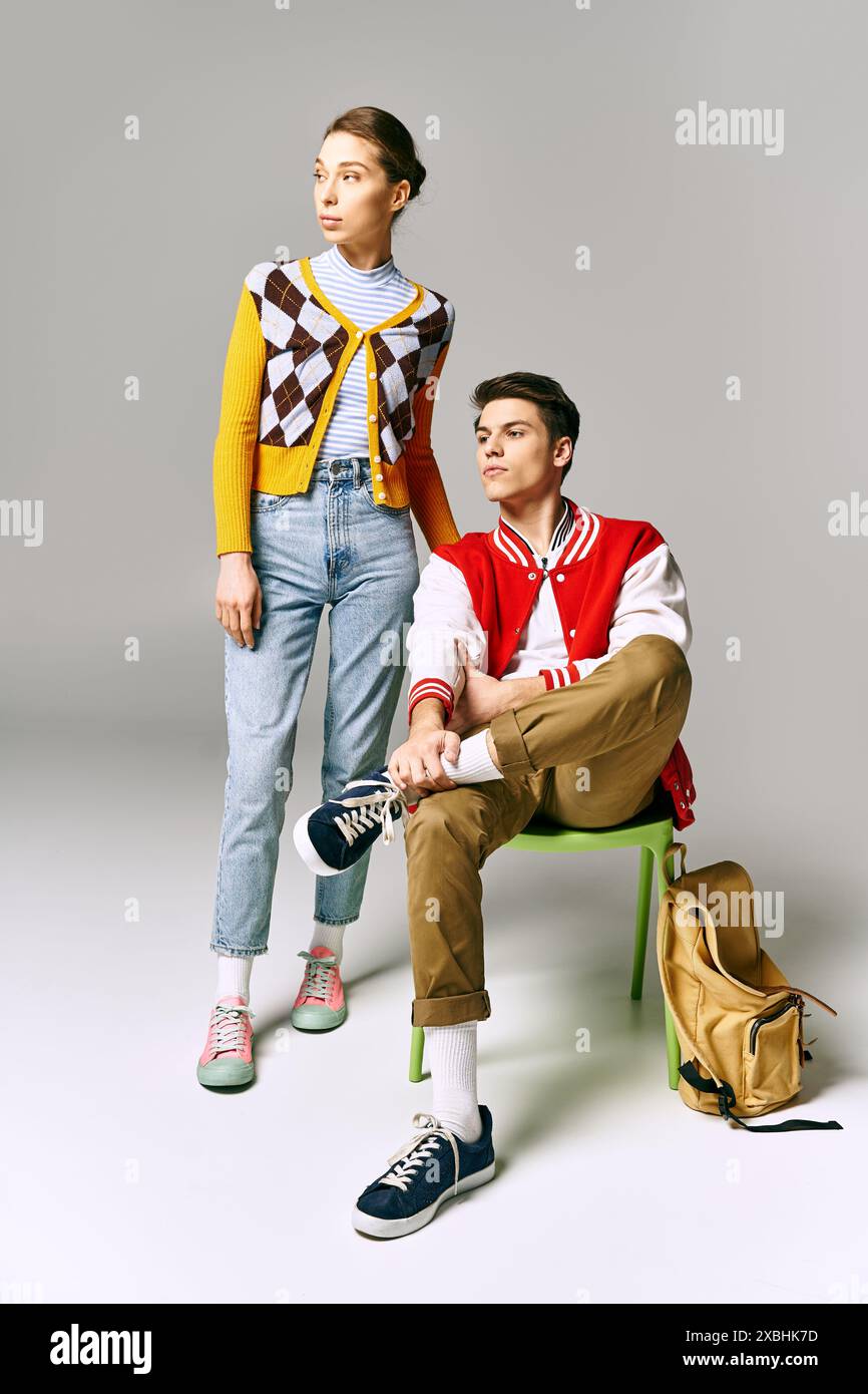Attractive students pose on a chair in a college classroom Stock Photo ...