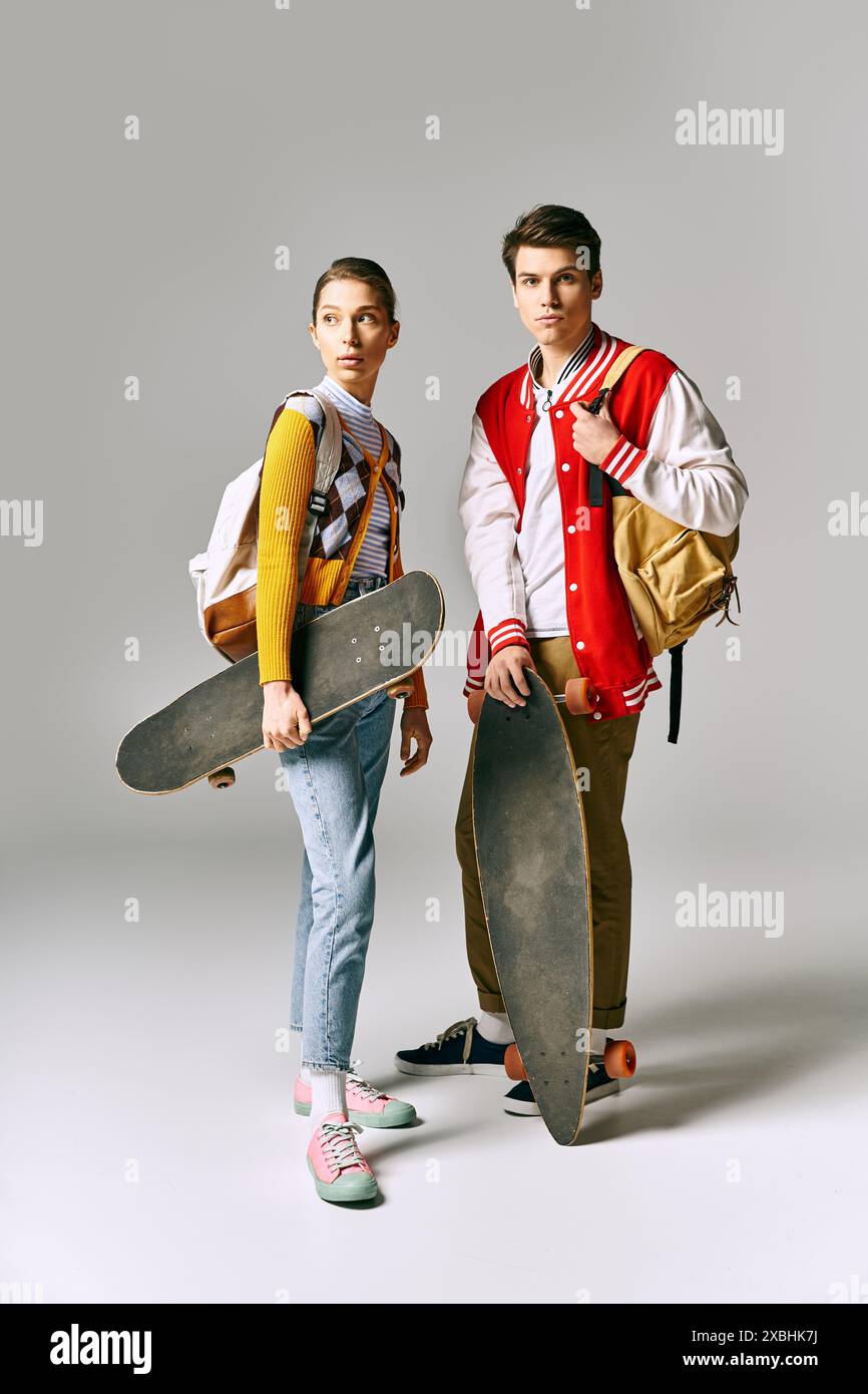 Two students strike a cool pose with skateboards Stock Photo - Alamy
