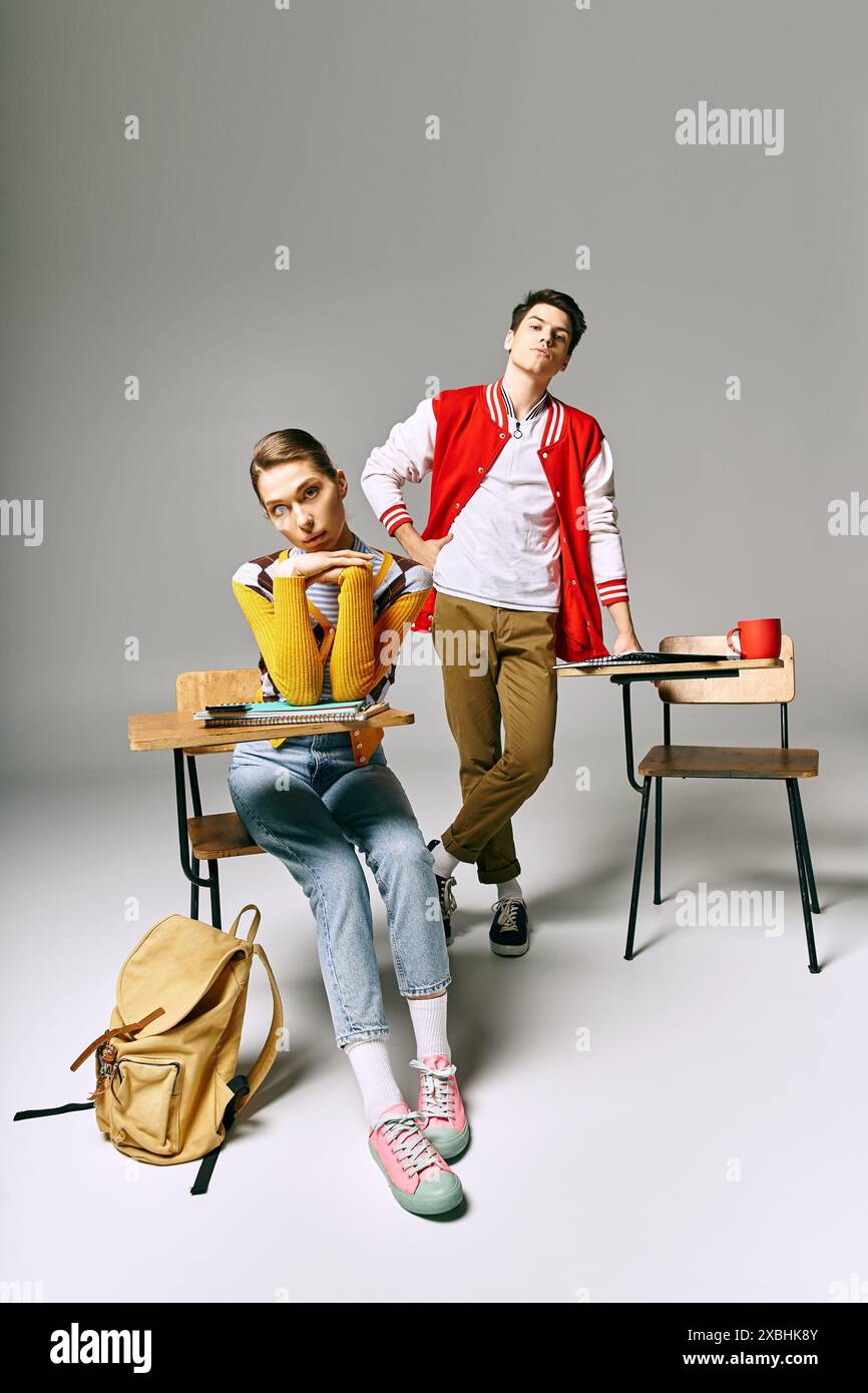 Attractive male and female students posing casually in a college ...