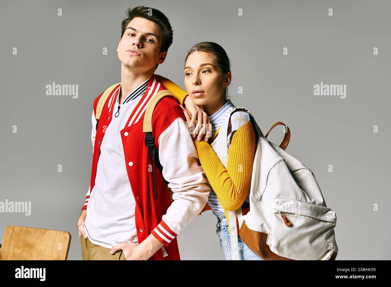 Young male and female students, stylishly dressed, posing together in a ...