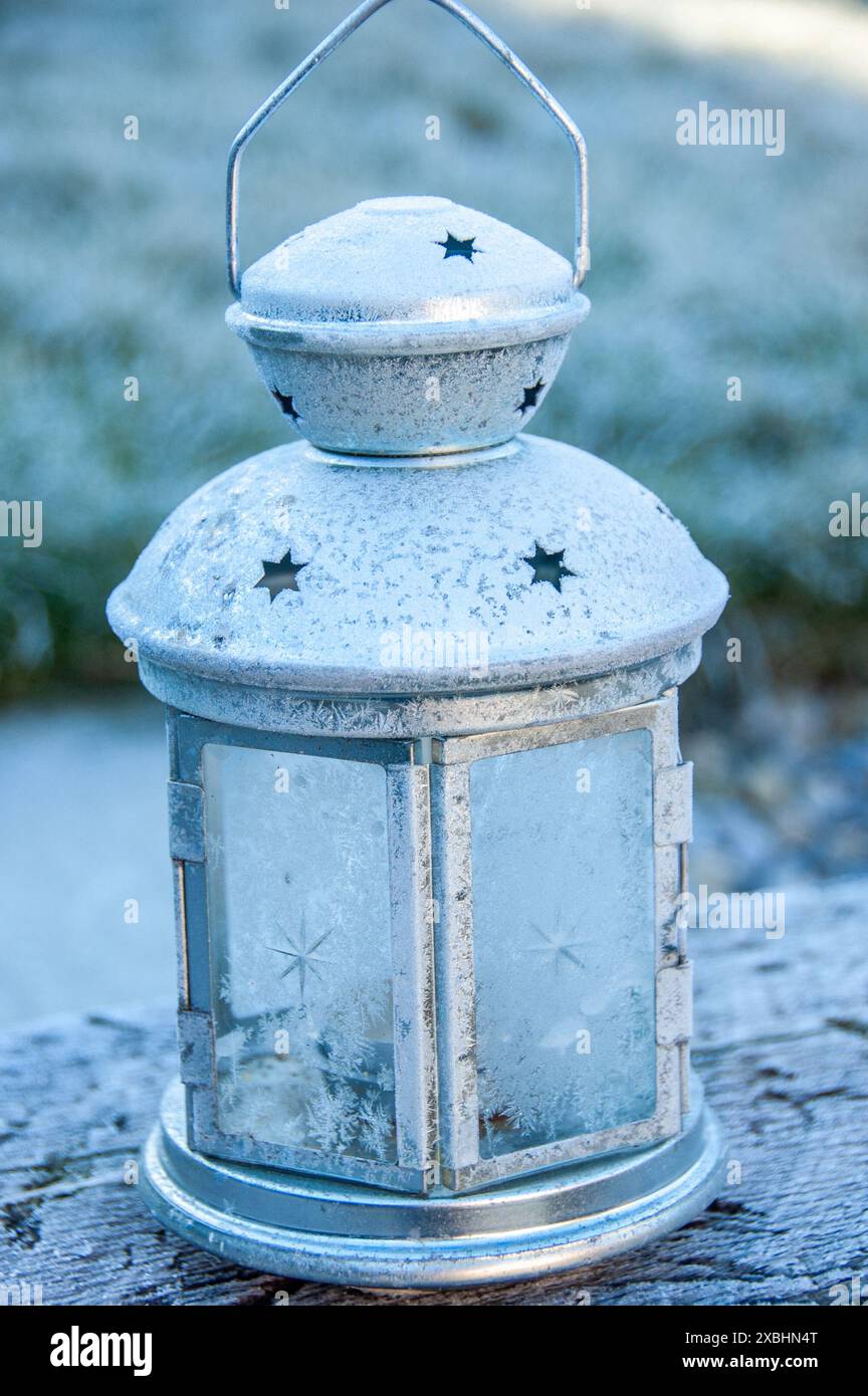 Garden decorative lantern coated in early morning frost on a crisp ...
