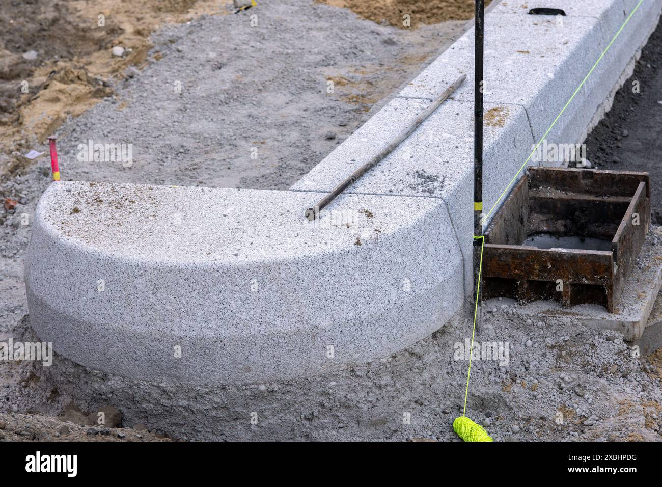 Installation of a wide curb with a sewer shaft Stock Photo - Alamy