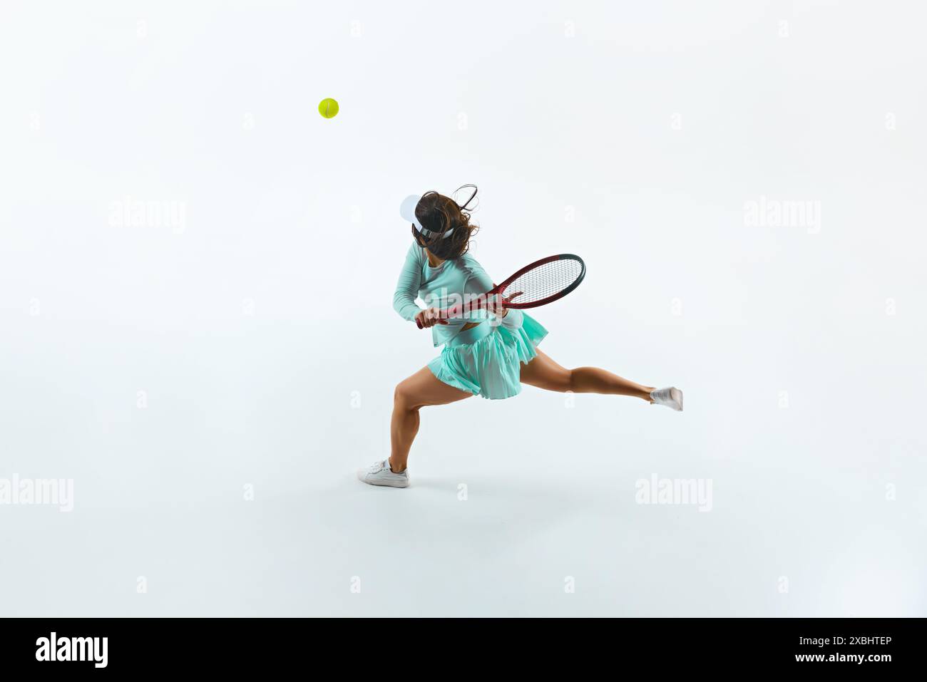 Athletic tennis player in turquoise attire executes forehand swing, her ...