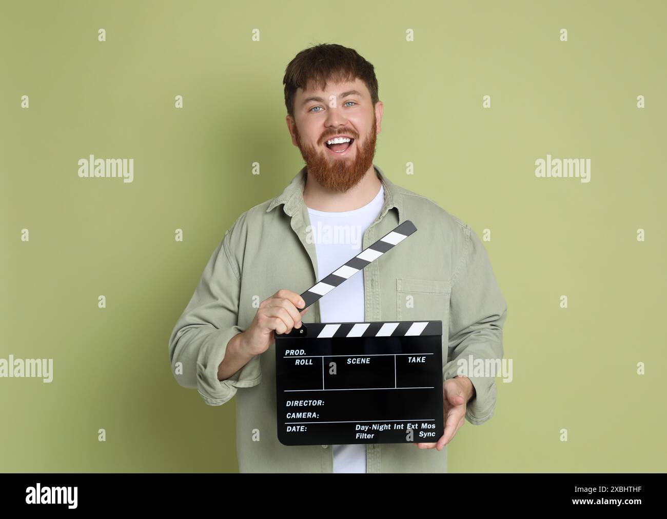 Making movie. Smiling man with clapperboard on green background Stock ...