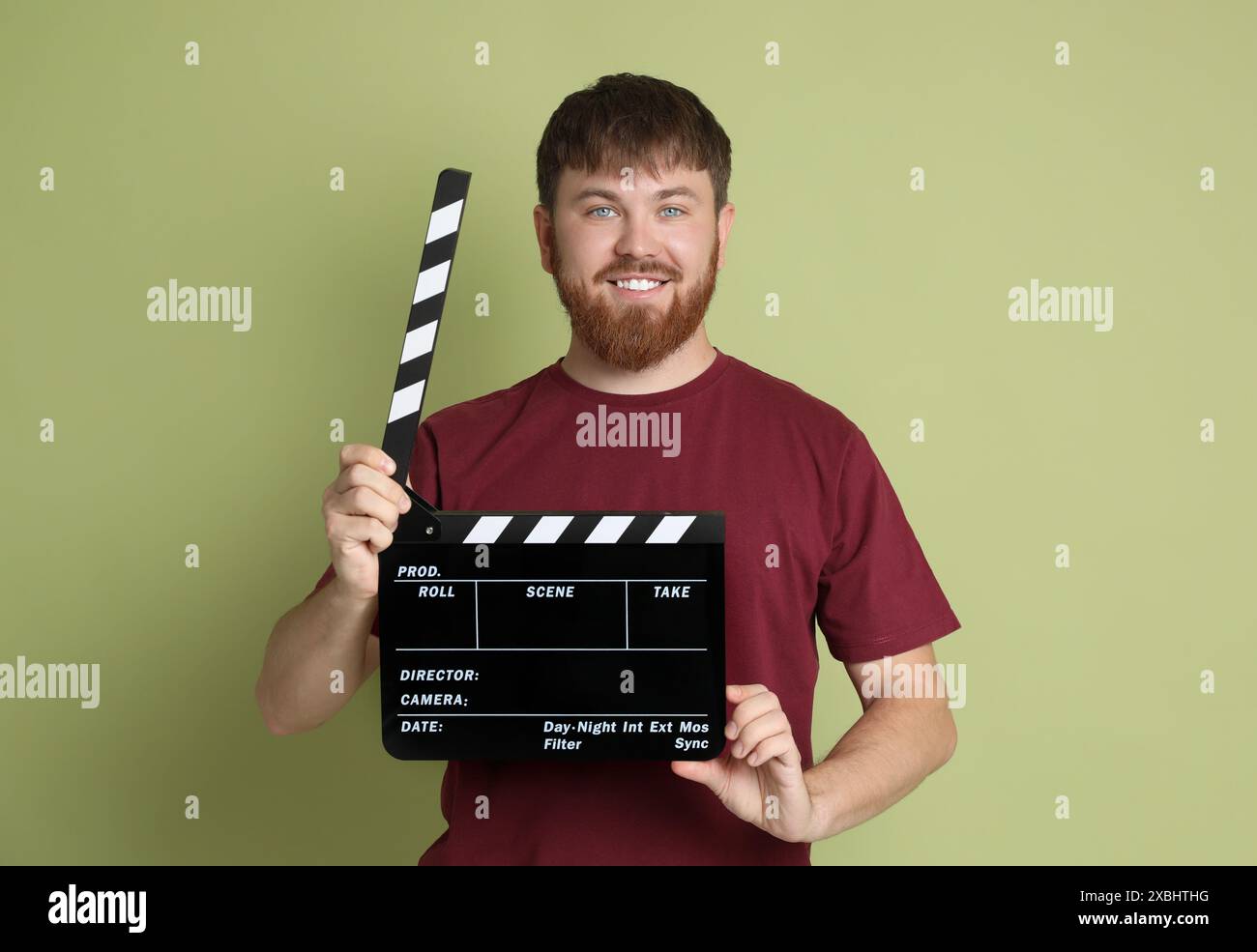 Making movie. Smiling man with clapperboard on green background Stock ...