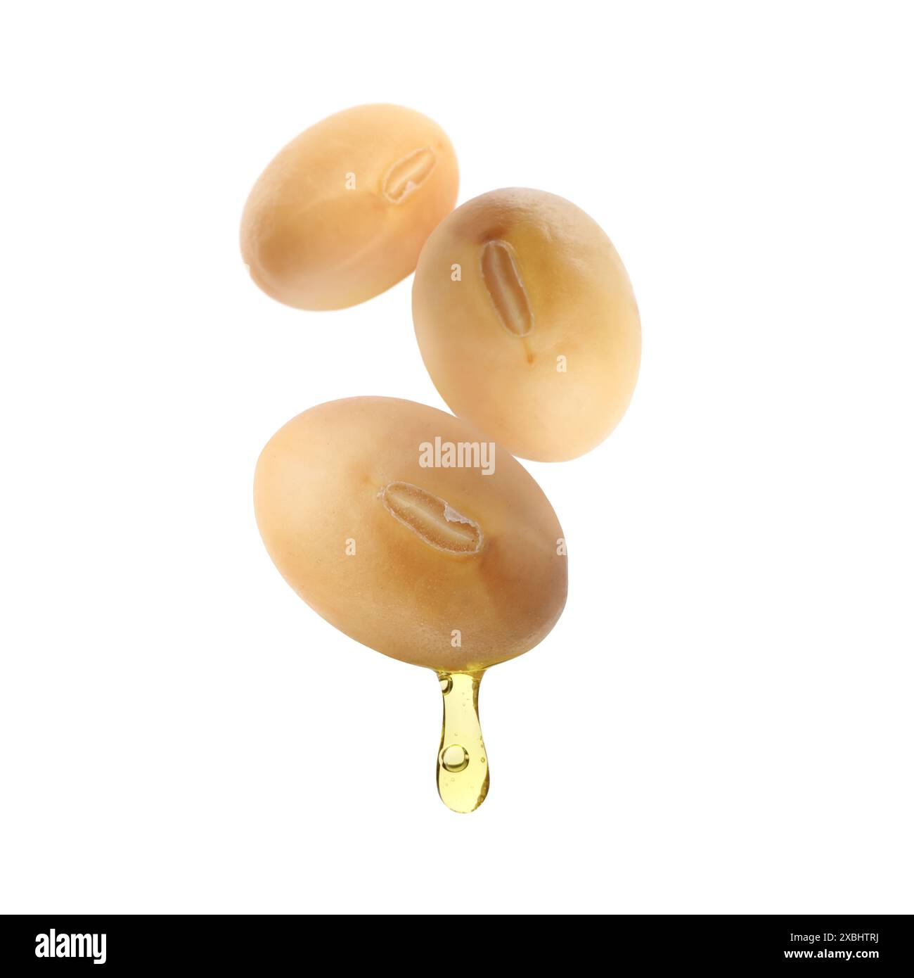 Cooking oil dripping from soybeans on white background Stock Photo - Alamy
