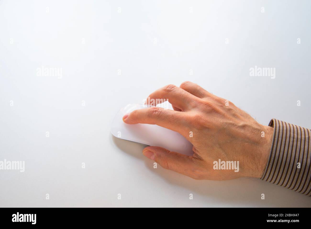 Man's hand using computer mouse Stock Photo - Alamy