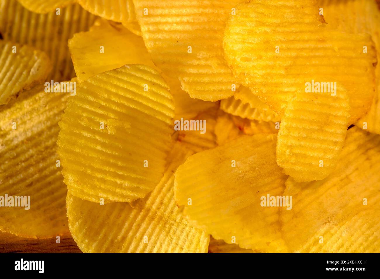 Close-up view of abundant crispy potato chips filling the frame for a ...