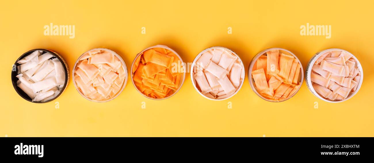 Multi-colored snus sachets with different flavors are placed in jars on ...