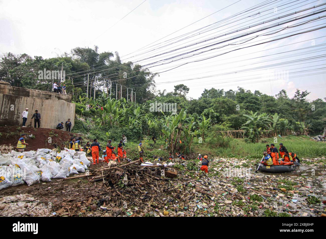 West Bandung Regency, Indonesia. 12th June, 2024. Officers cleaning up the piled up garbage in ...