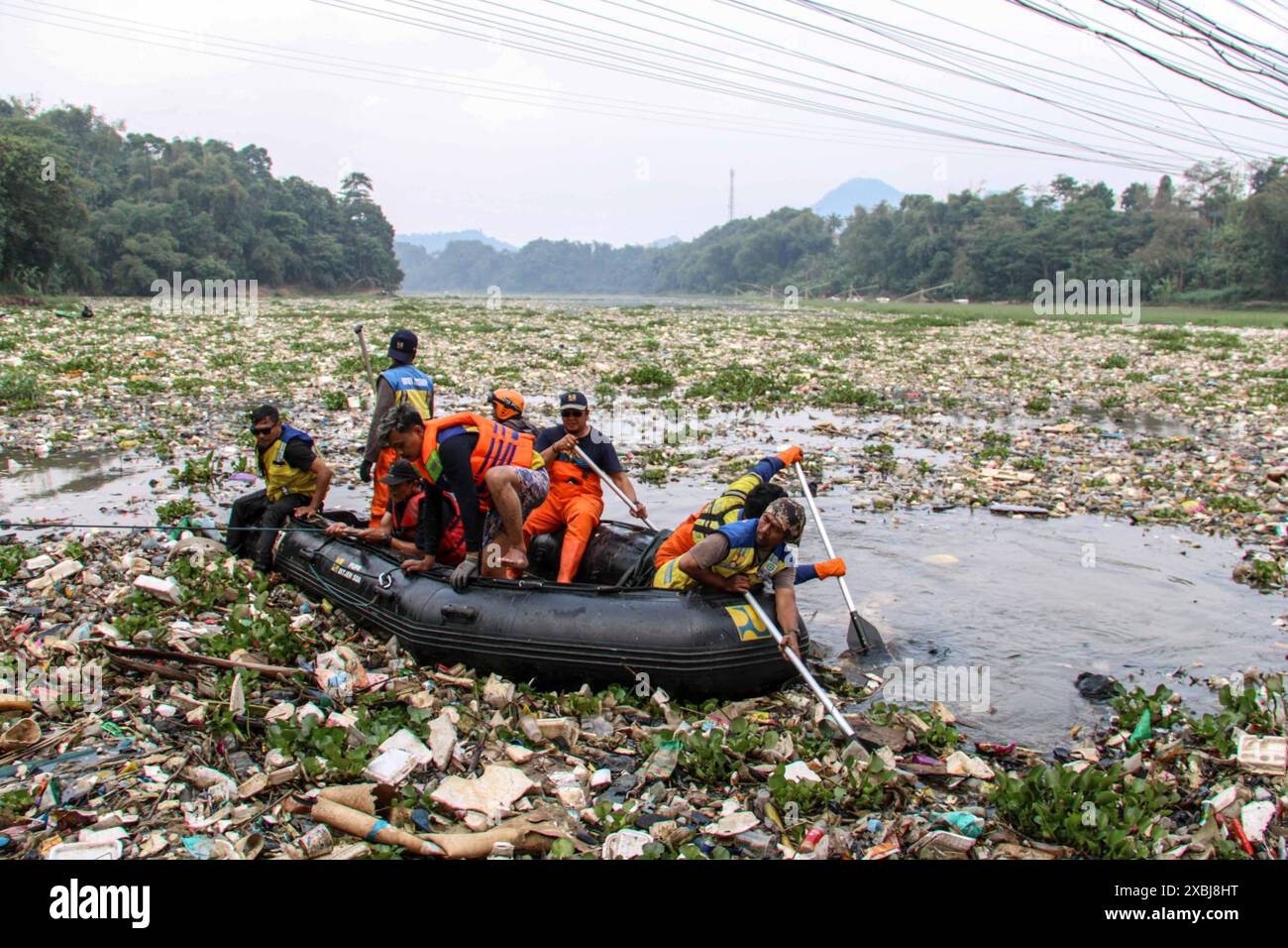 West Bandung Regency, Indonesia. 12th June, 2024. Officers cleaning up the piled up garbage in ...