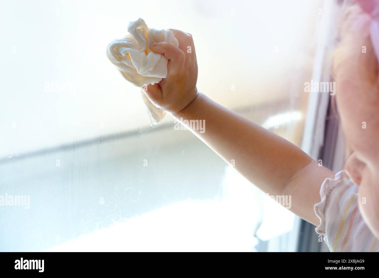 close-up female children's hand washing window, little helper, daughter ...