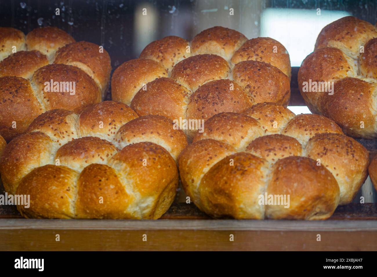 Freshly baked flower shaped bread rolls with a golden crust displayed ...