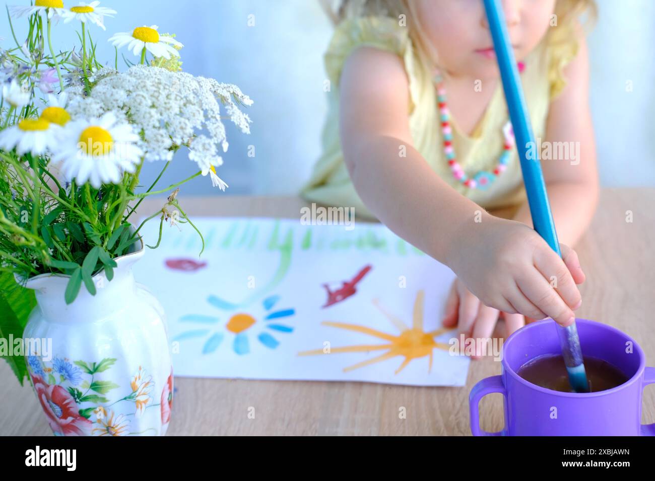children's hand paints with brush, small child, little girl preschooler ...