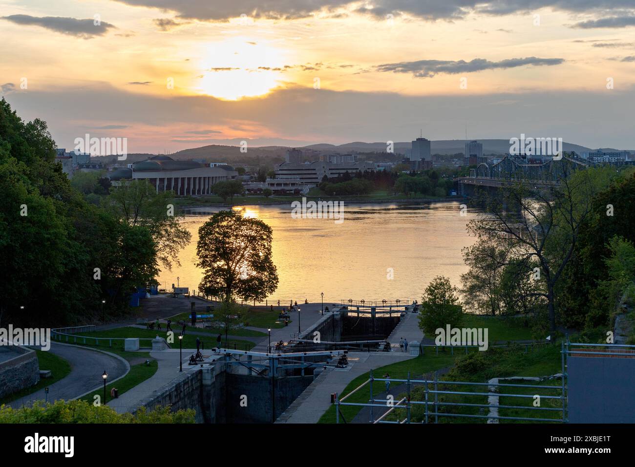Ottawa, Canada - May 16, 2024: Rideau canal locks and Ottawa River in downtown during sunset ...