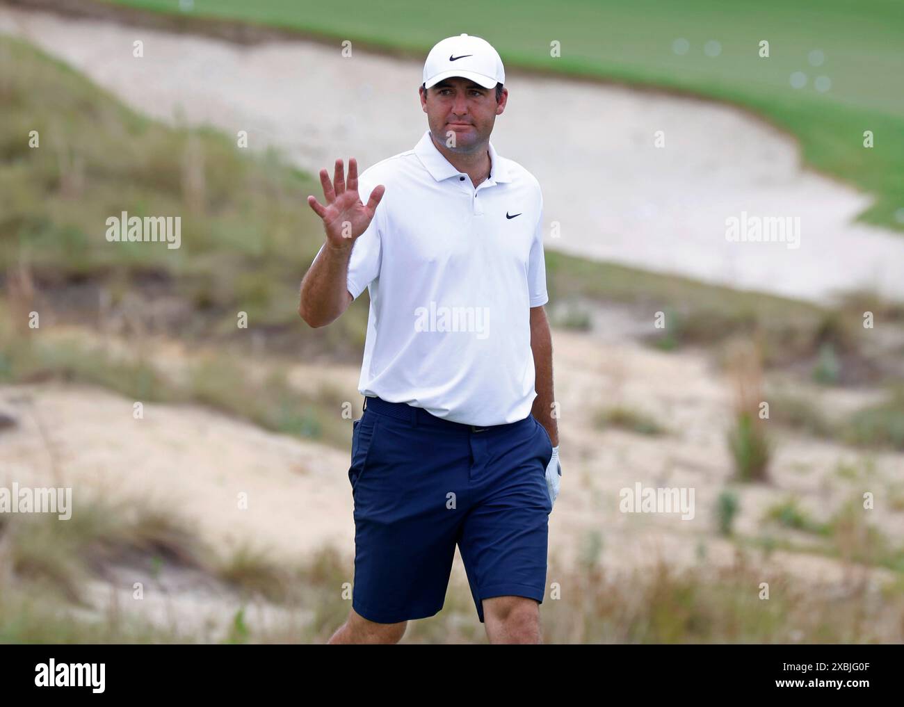 World number one golfer Scottie Scheffler waves to the gallery during a ...