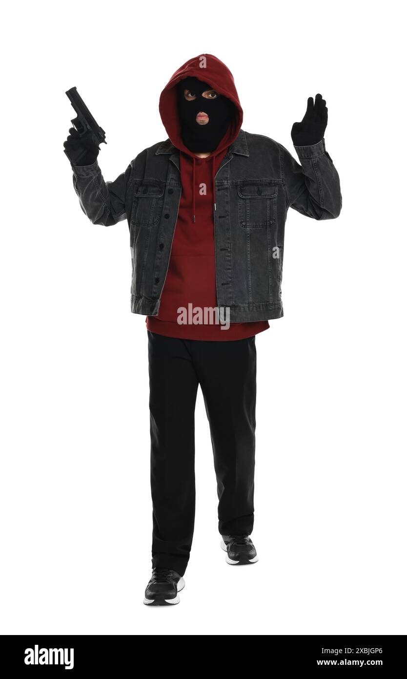 Thief in balaclava raising hands with gun on white background Stock ...