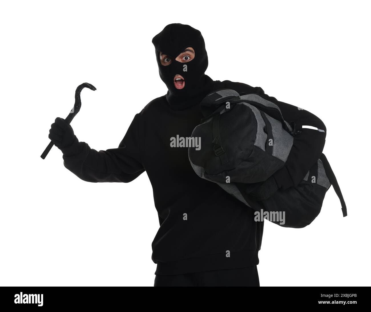 Emotional thief in balaclava with crowbar and bag on white background ...