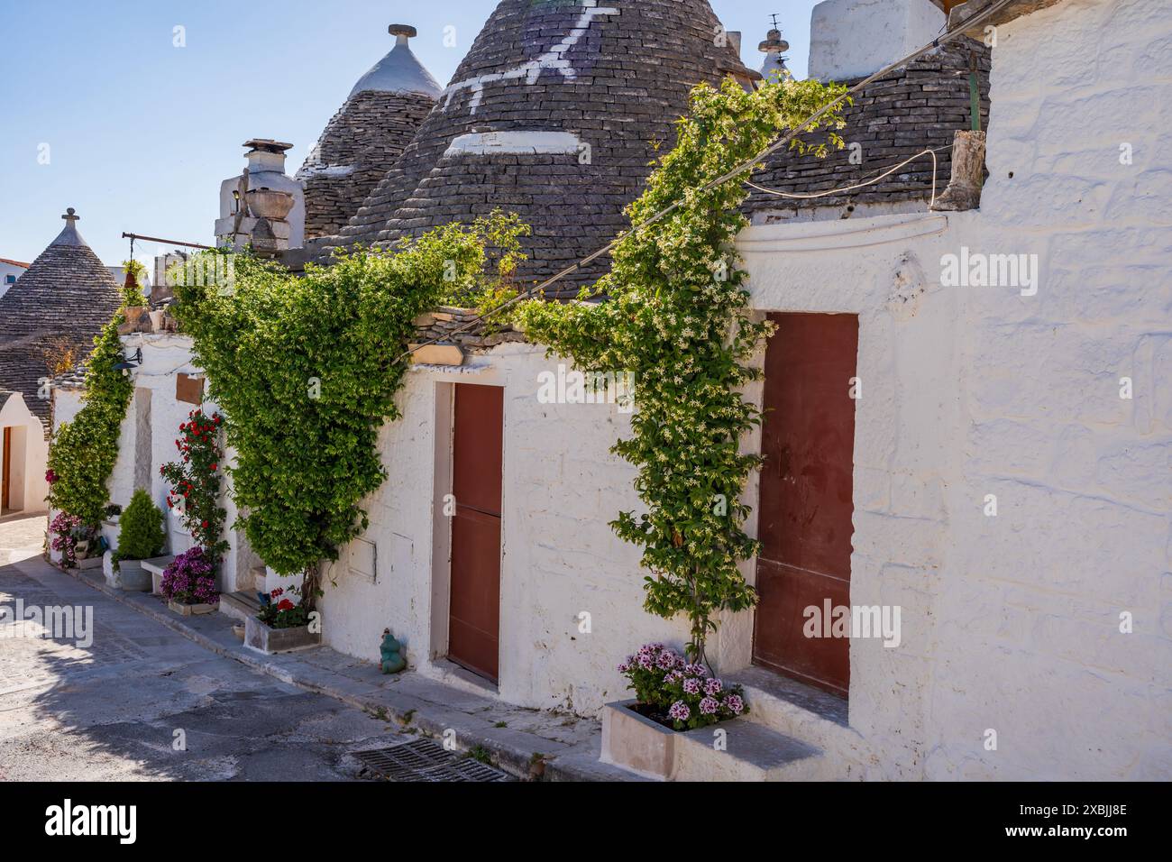 Famous traditional old dry stone trulli houses with conical roofs in ...