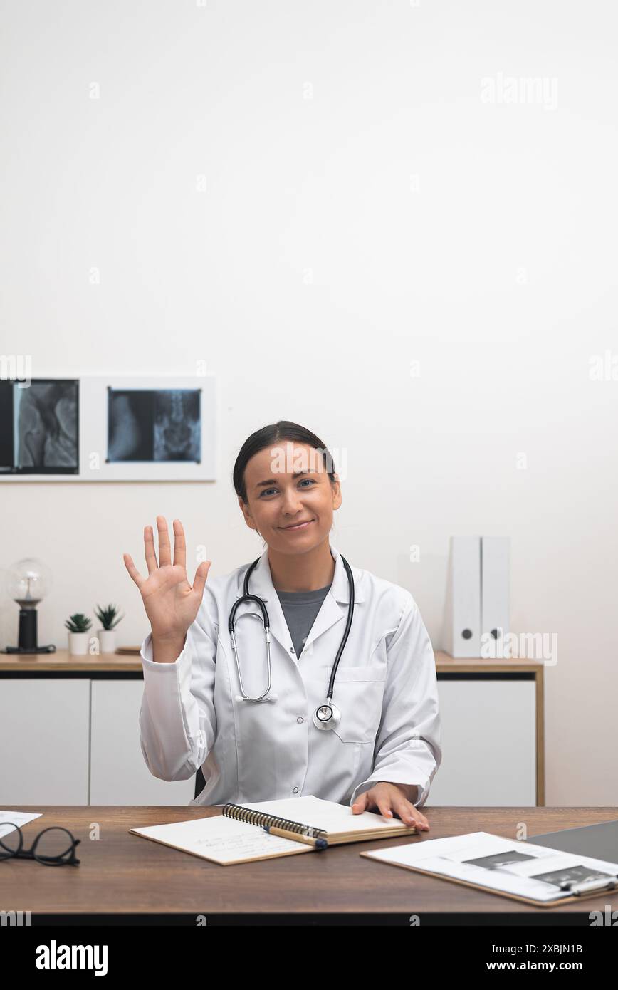 Doctor waving hand laptop screen hi-res stock photography and images ...