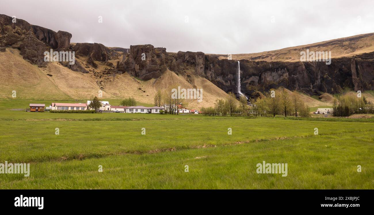 Rural Icelandic Farm With Waterfall and Dramatic Cliffs Stock Photo - Alamy