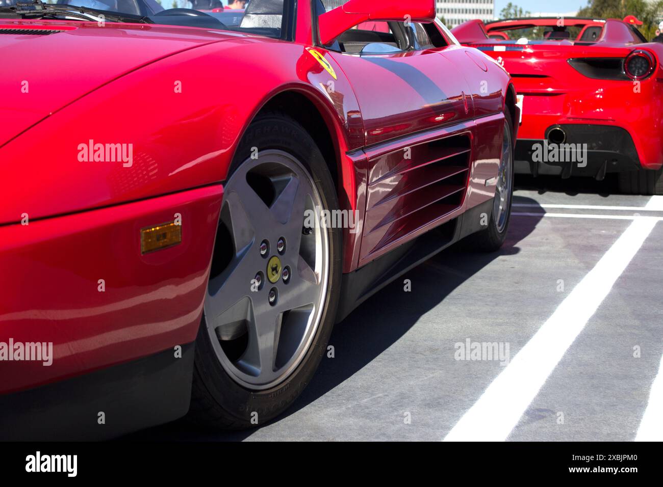 A photo highlighting the front, driver-side of a Ferrari 348 with it's ...