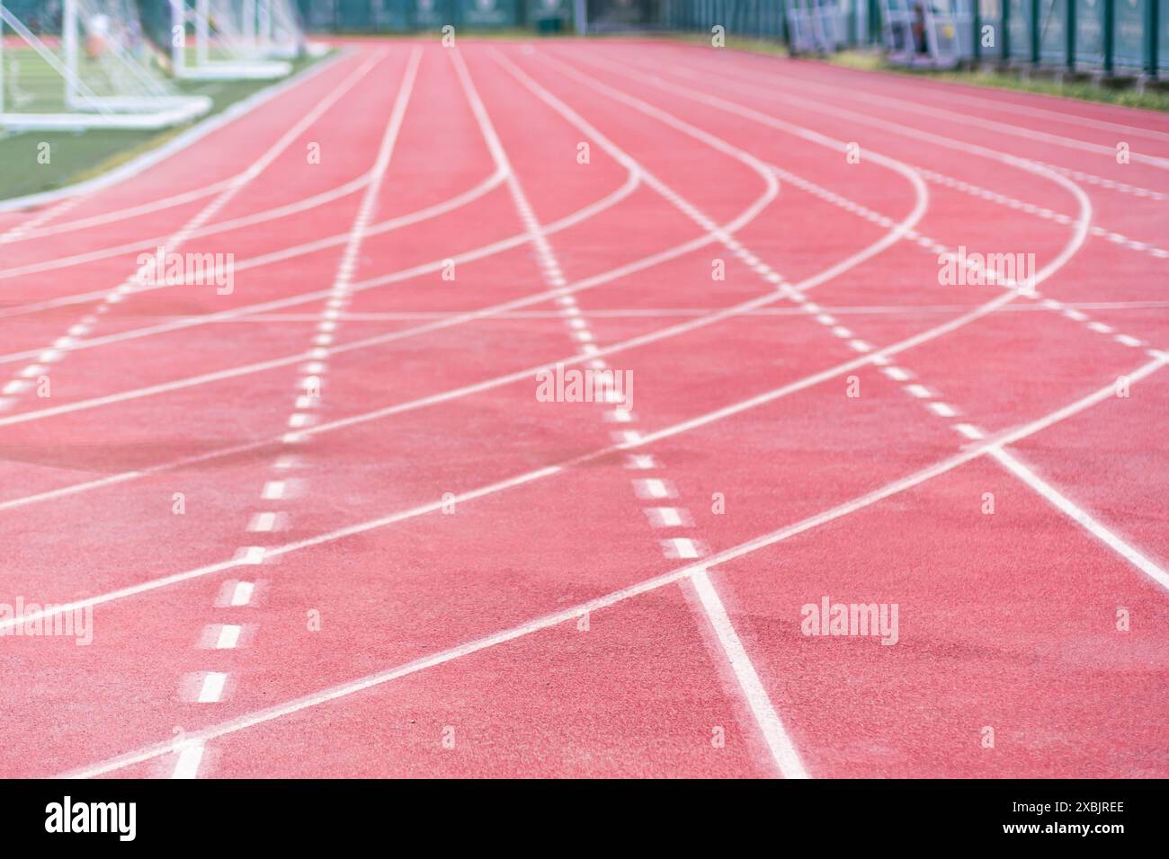 red color padded rubber running track in sport stadium, with painted ...