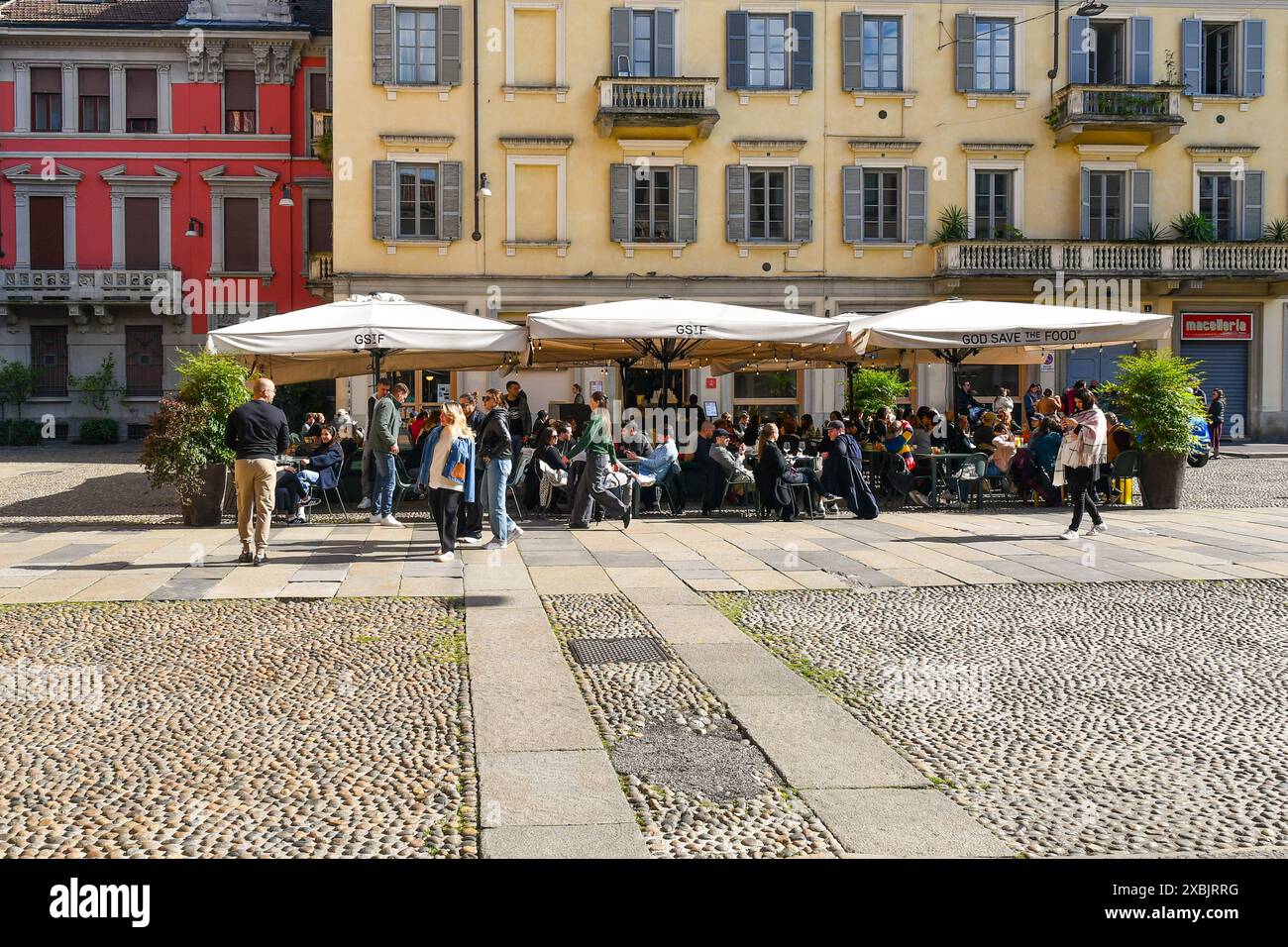 People having an aperitif in an outdoor bar in Piazza del Carmine, a ...