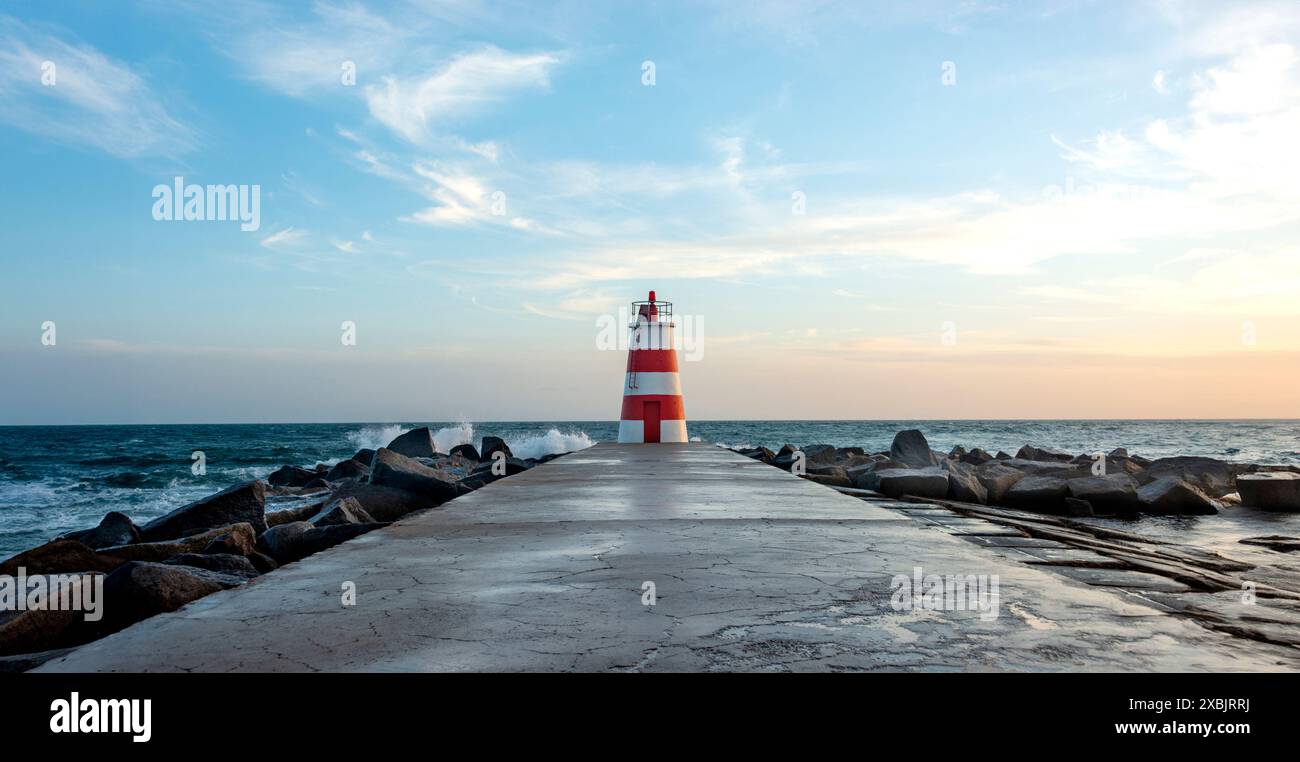 red and white lighthouse by the sea Stock Photo - Alamy