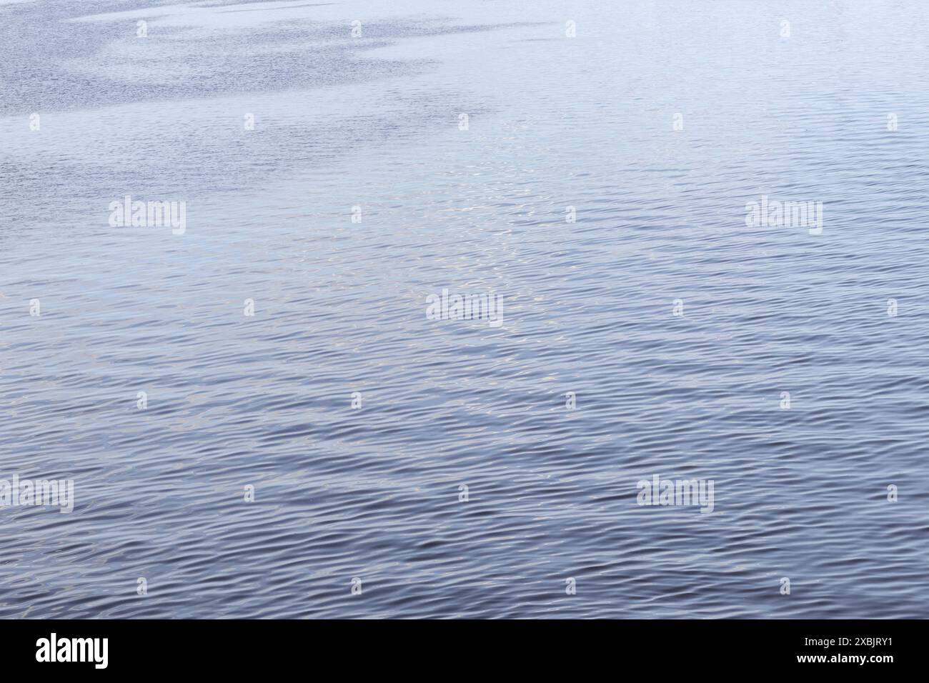 Sparkling blue water with small waves in it Stock Photo - Alamy