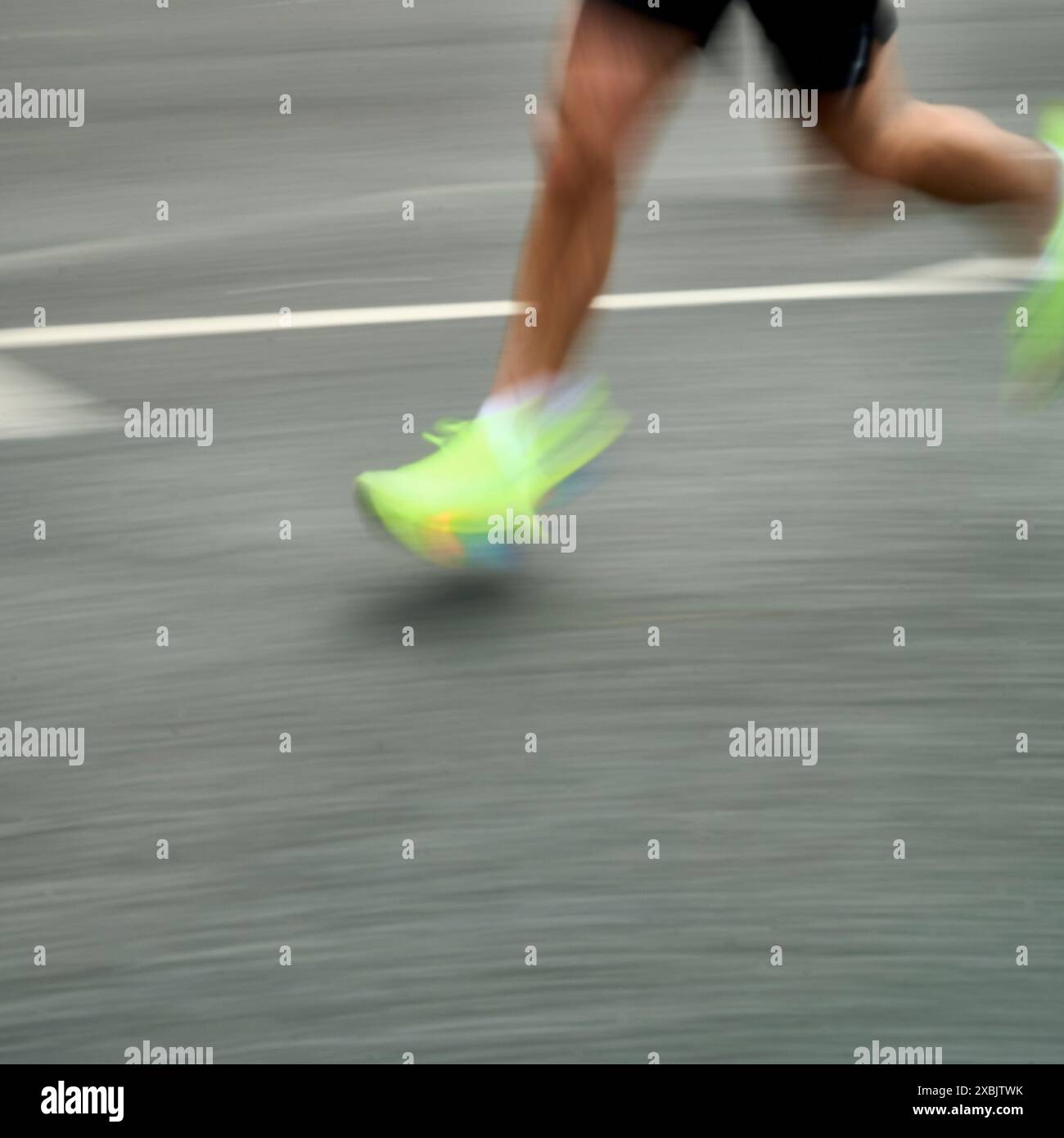 Motion blur of a road runners feet and lower legs on road surface Stock ...