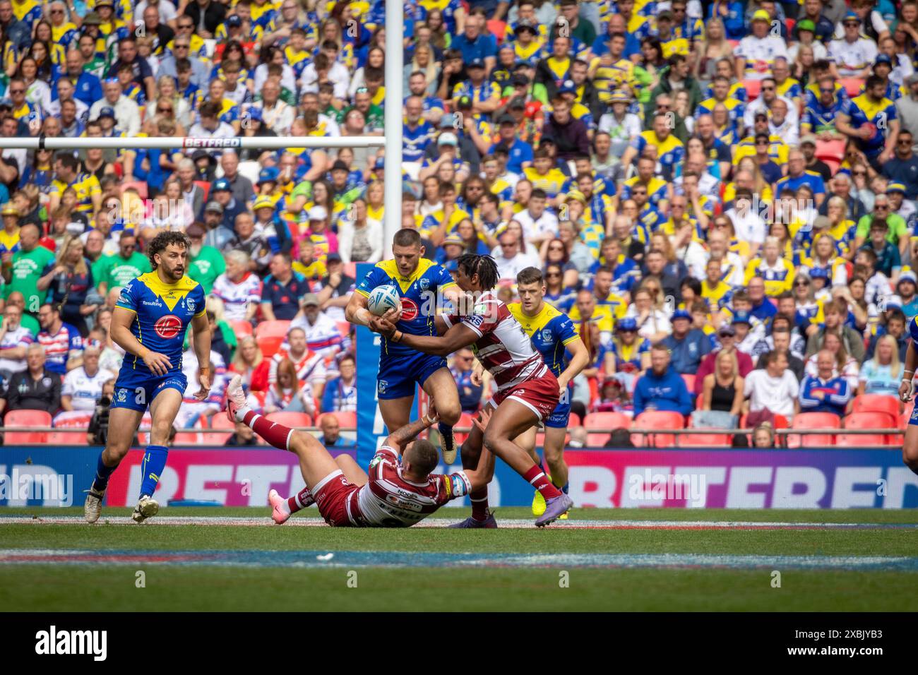 The 2024 Betfred Challenge Cup Final. Nsemba tackles Danny Walker who ...