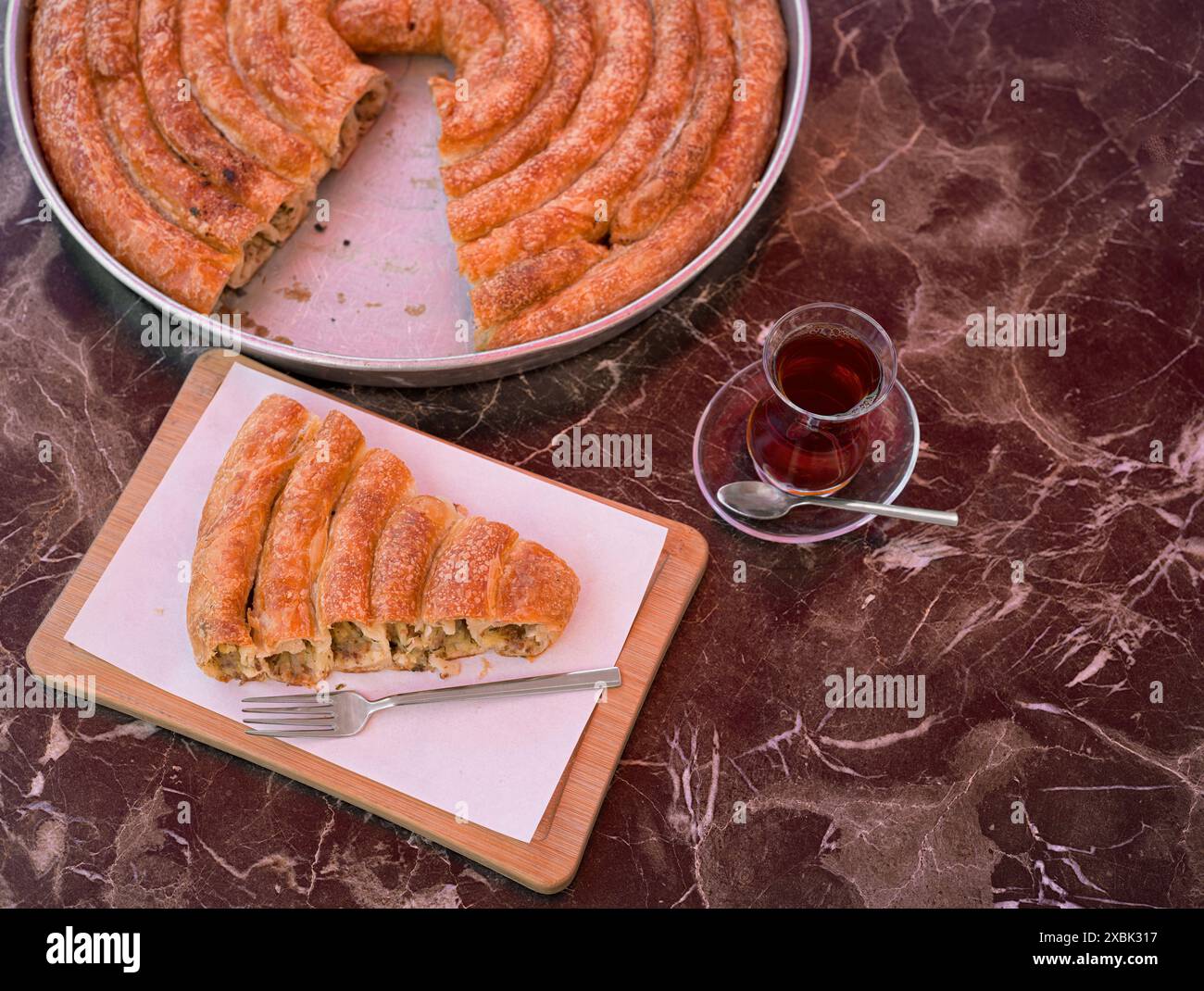 Overhead view of Turkish borek (boregi) on a marbled table served with ...