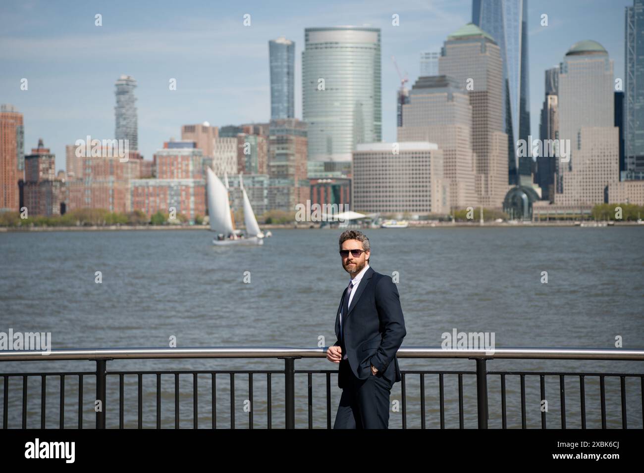 Confident rich business man executive standing in New York City ...