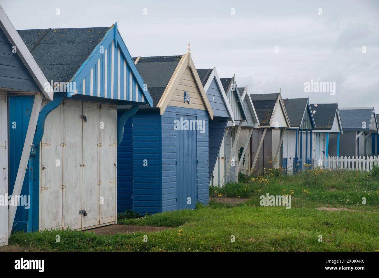 Beach huts along the sea front on the beach at Sutton on Sea in ...
