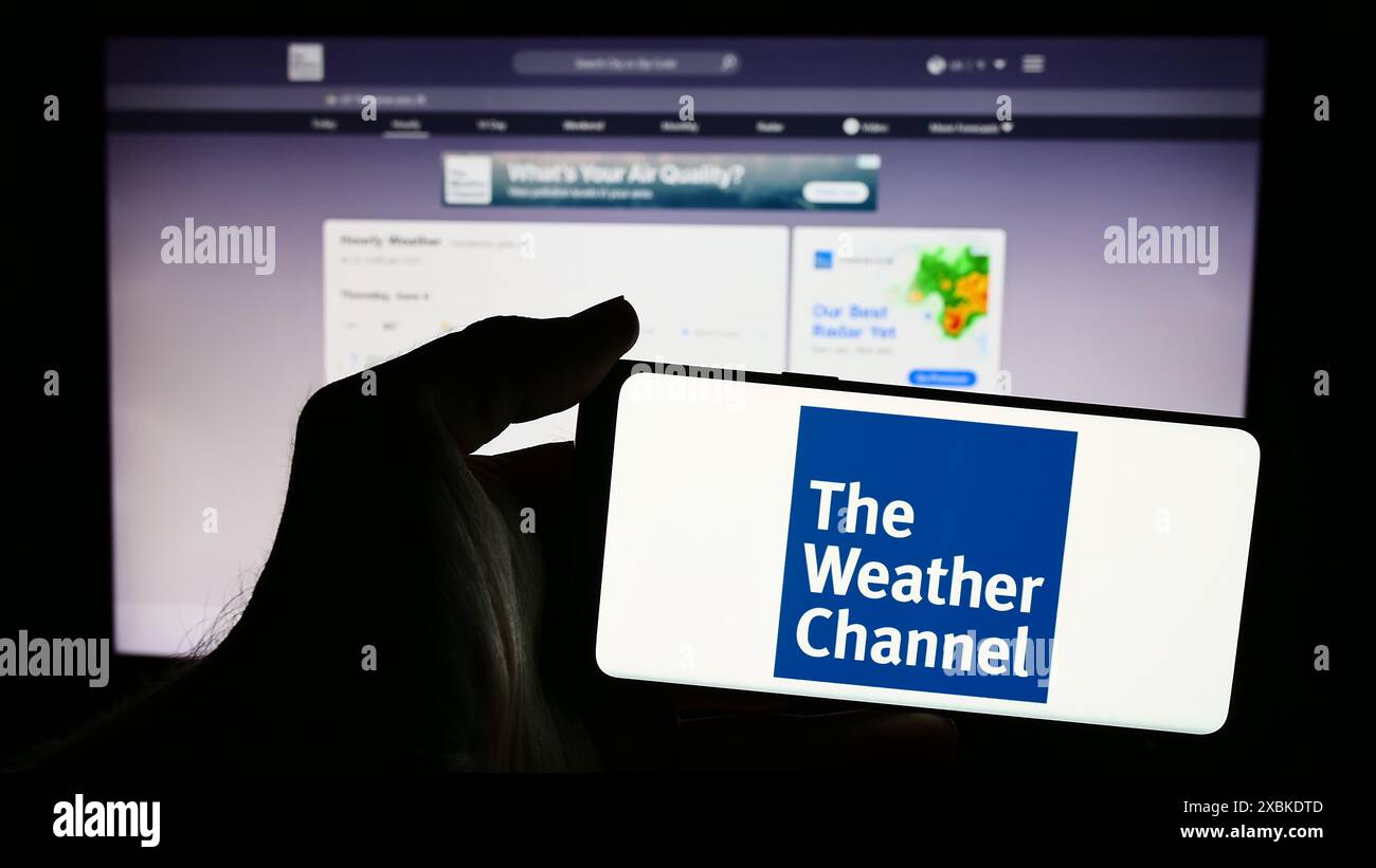 Person holding mobile phone with logo of American pay television ...