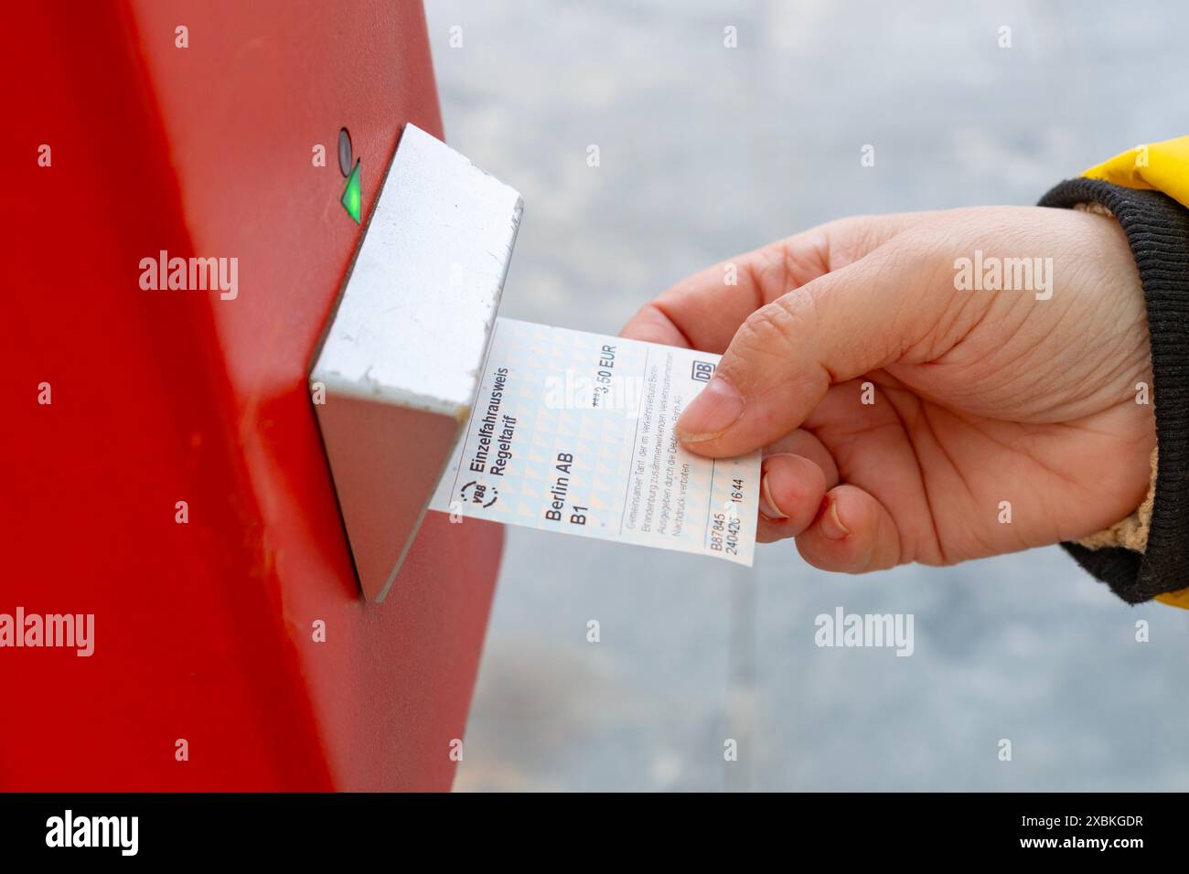 traveler, woman validating train ticket at terminal, public ...