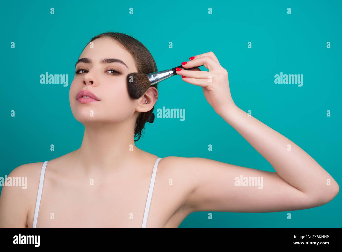 Girl hold blush blusher apply powder visage isolated over studio ...